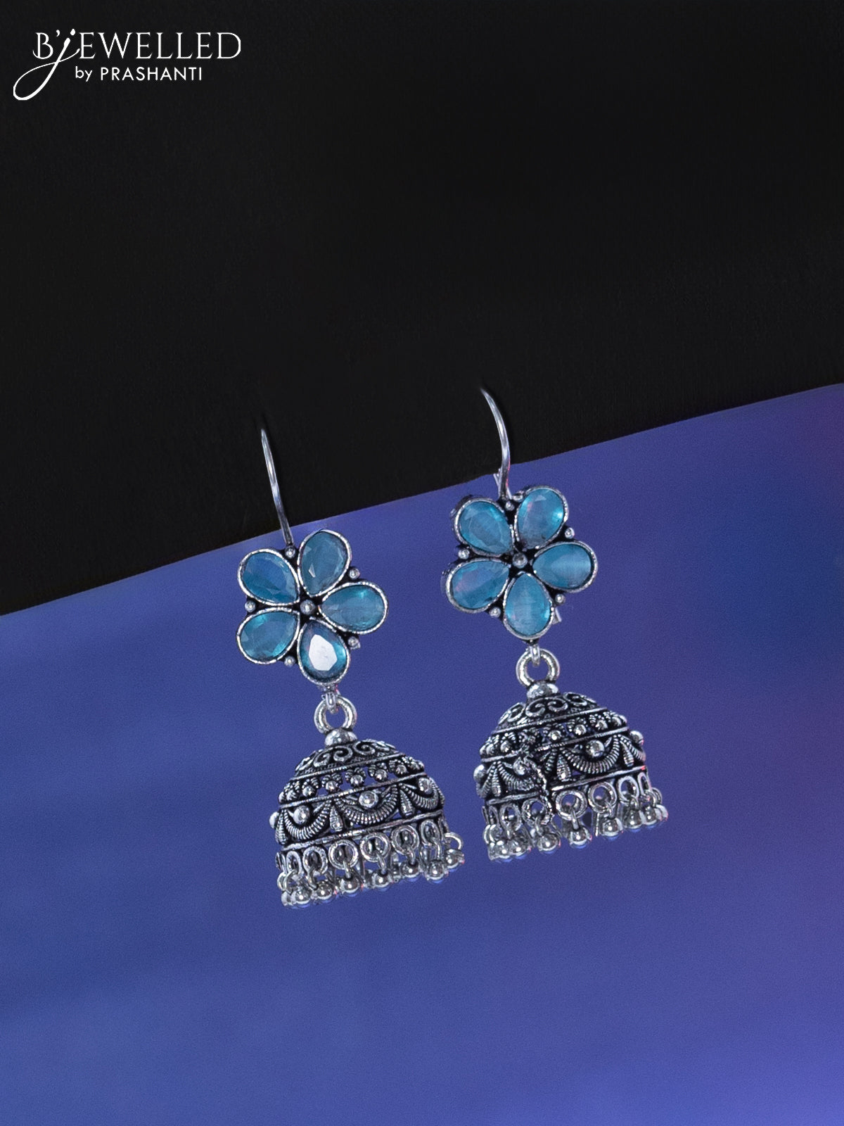 Oxidised hanging type jhumka floral design with ice blue stone and han ...